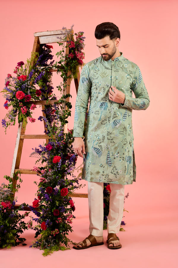 mint green thread work kurta with intricate flora and fauna emnroidery